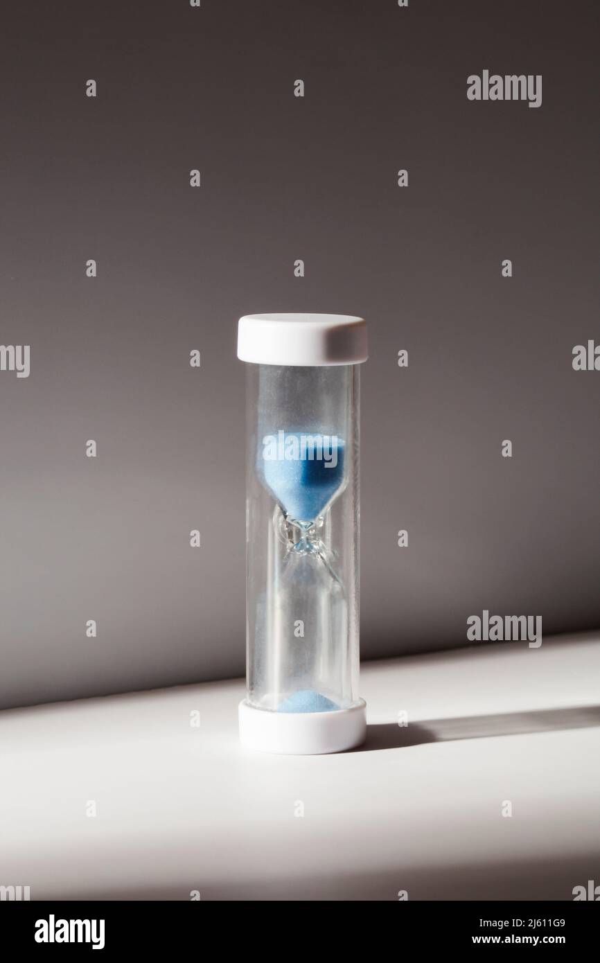 hourglass on dark background with shadow. concept of decision making ...