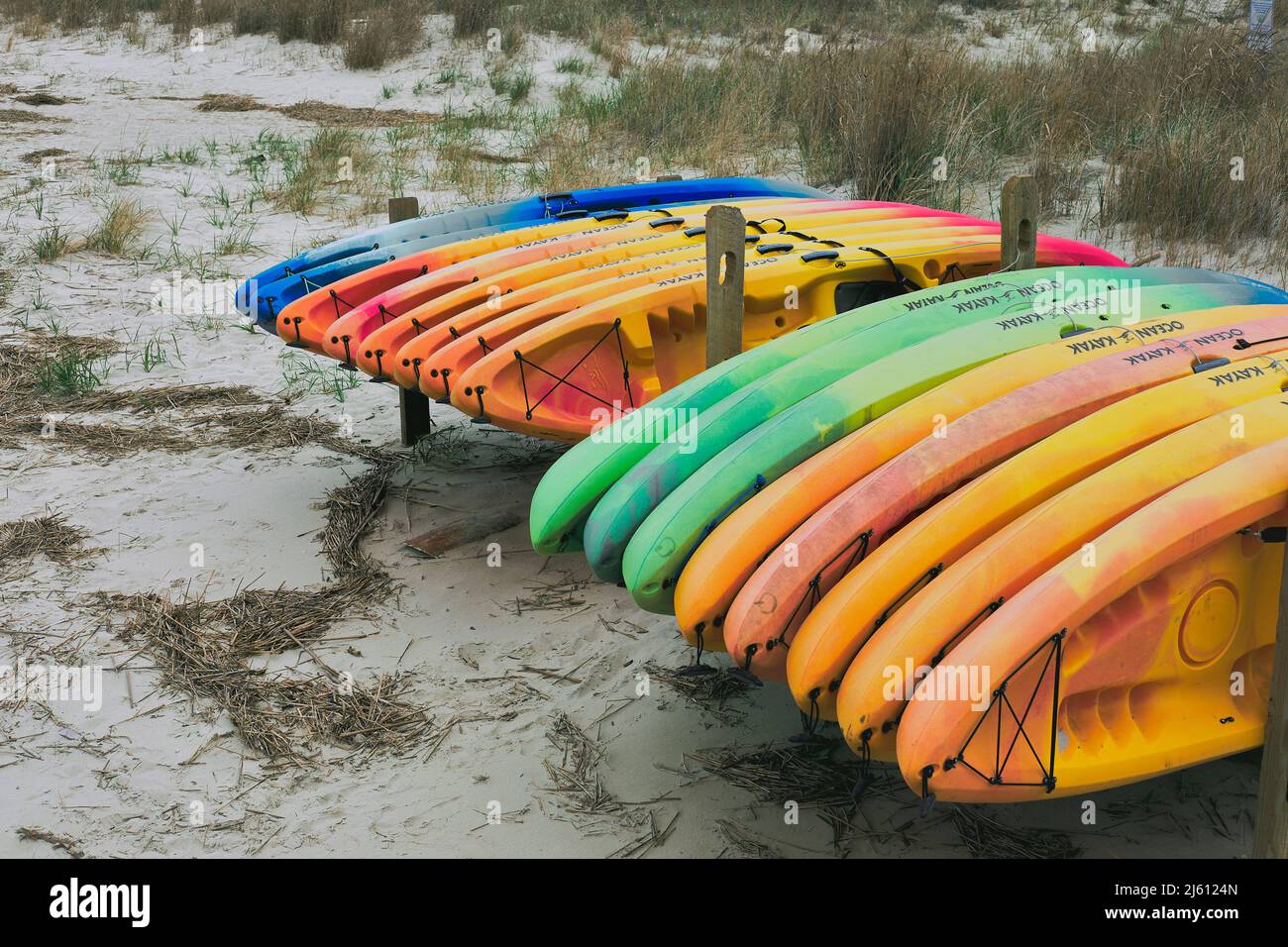 Multicolored plastic kayaks stand ready for rental on the Cape Henlopen ...
