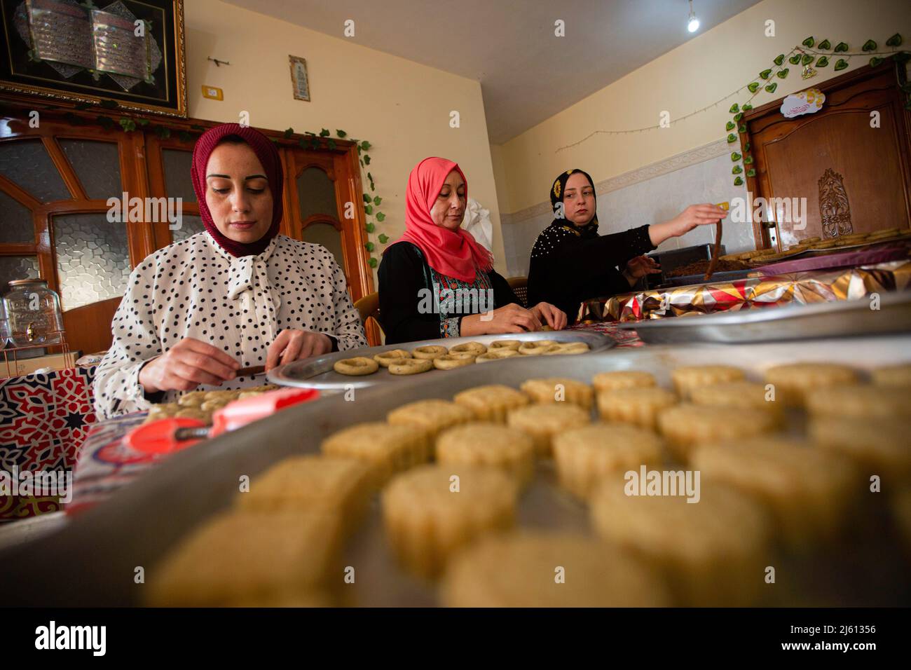 A Palestinian family makes traditional sweets at their home in the ...