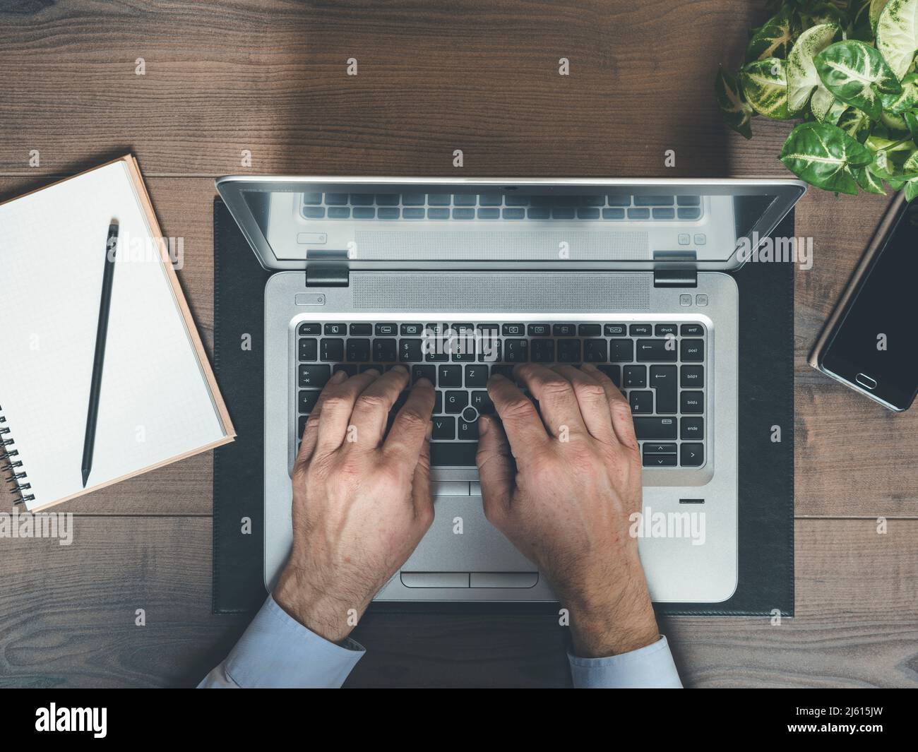 image shows modern workplace with laptop, notebook, cell phone like ...