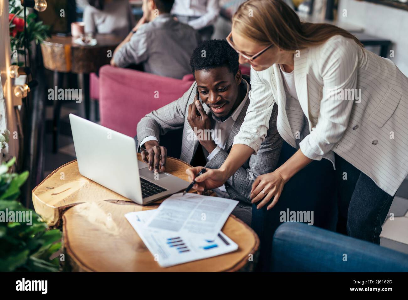 Woman approached a colleague with papers for an informal discussion ...