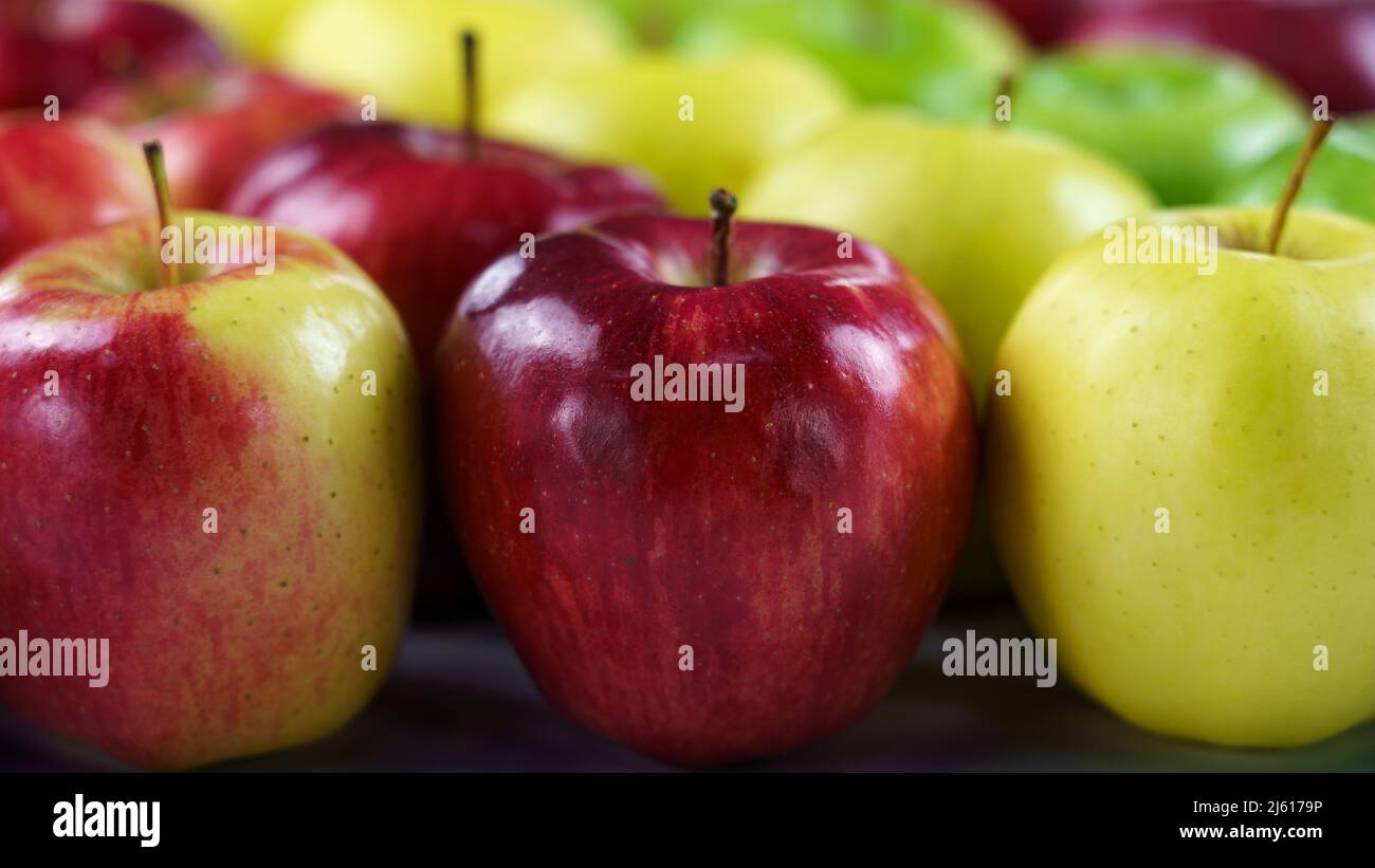 Several colored apples in a row forming a progressive blur background ...