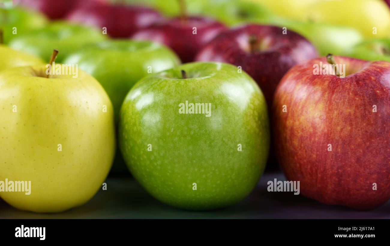 Several colored apples in a row forming a progressive blur background ...