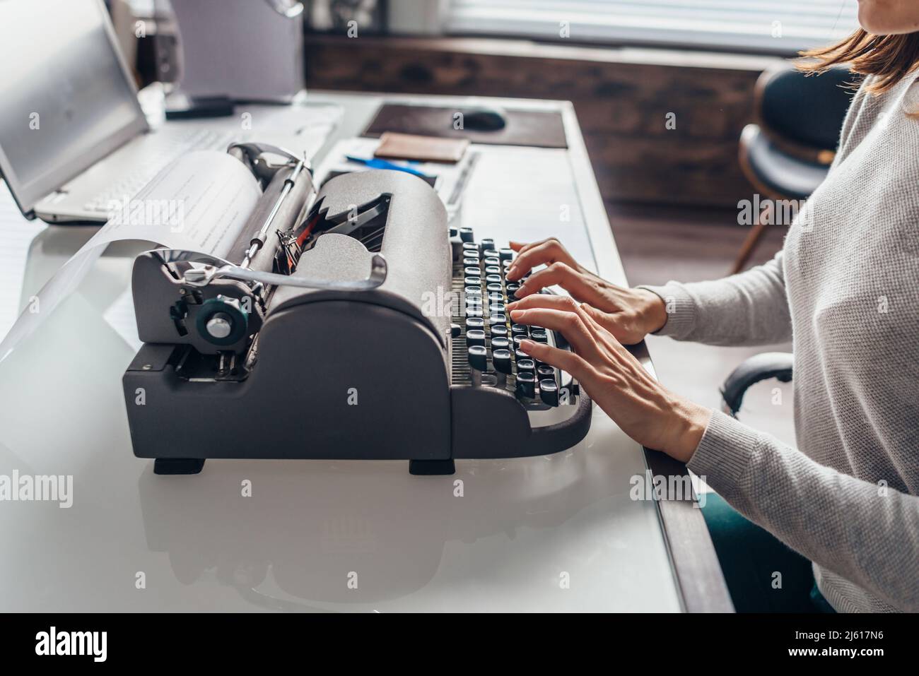 Young woman writing with an old typewriter Stock Photo - Alamy