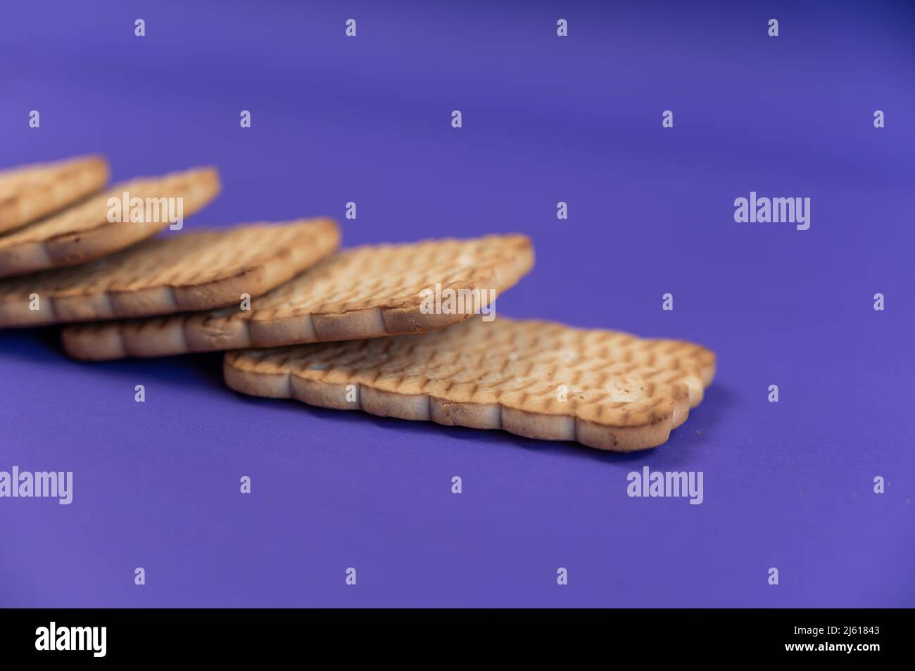 A stack of rectangular cookies against a blue background. Ready-to-eat ...