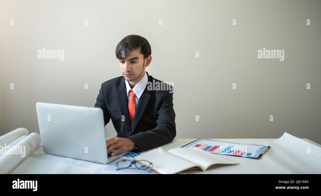 Business man working with laptop and documents on his desk.analyzing ...