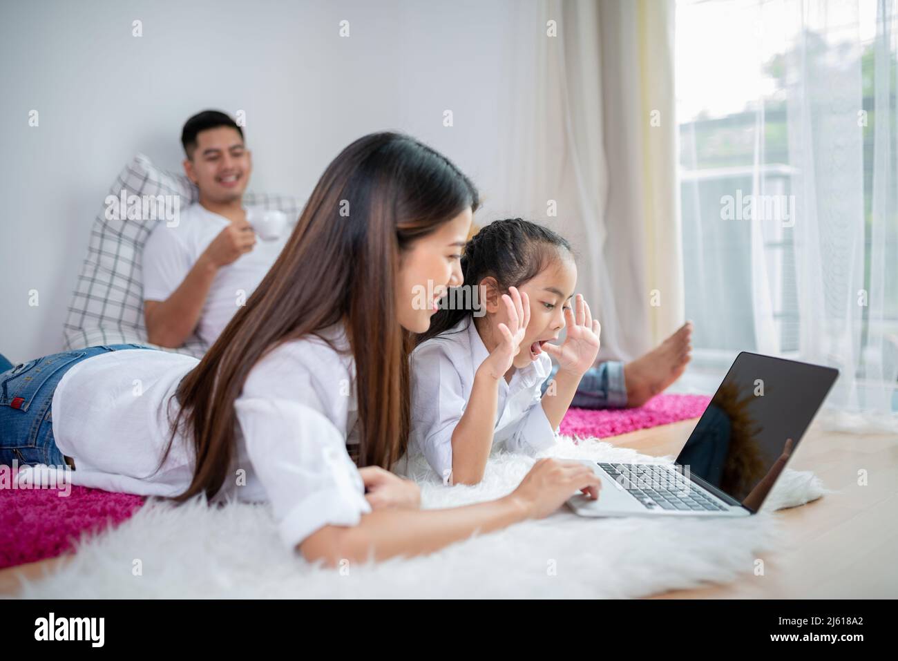 happy family mother, father, child daughter play laptop computer at ...