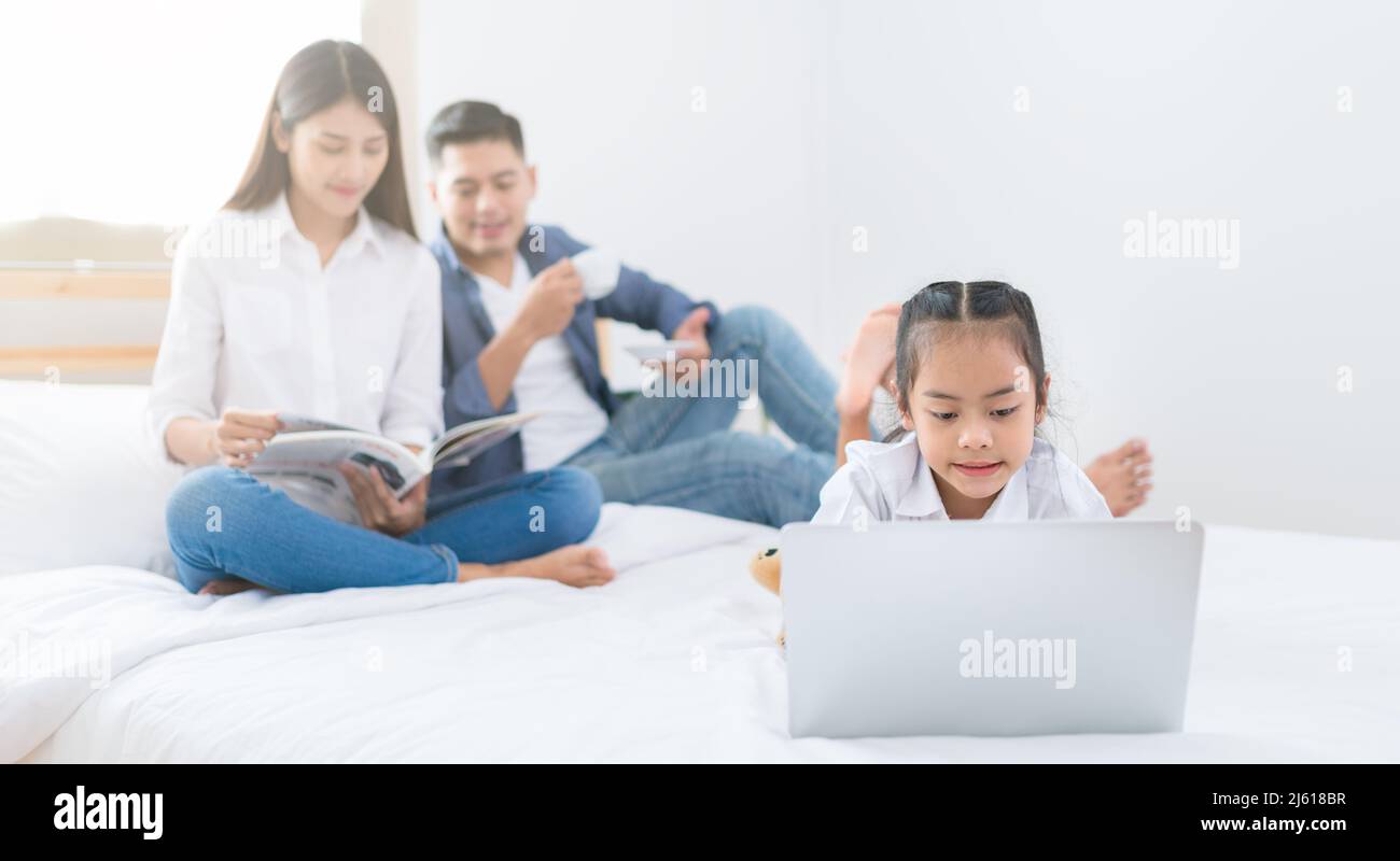 happy family mother, father, child daughter play laptop computer at ...