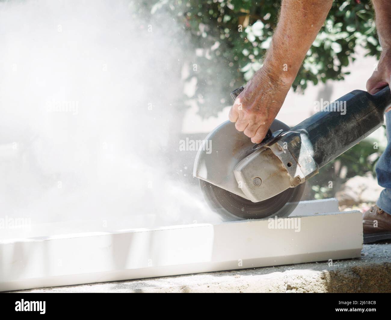 Bricklayer anonymouscutting plaster with construction tool Stock Photo ...