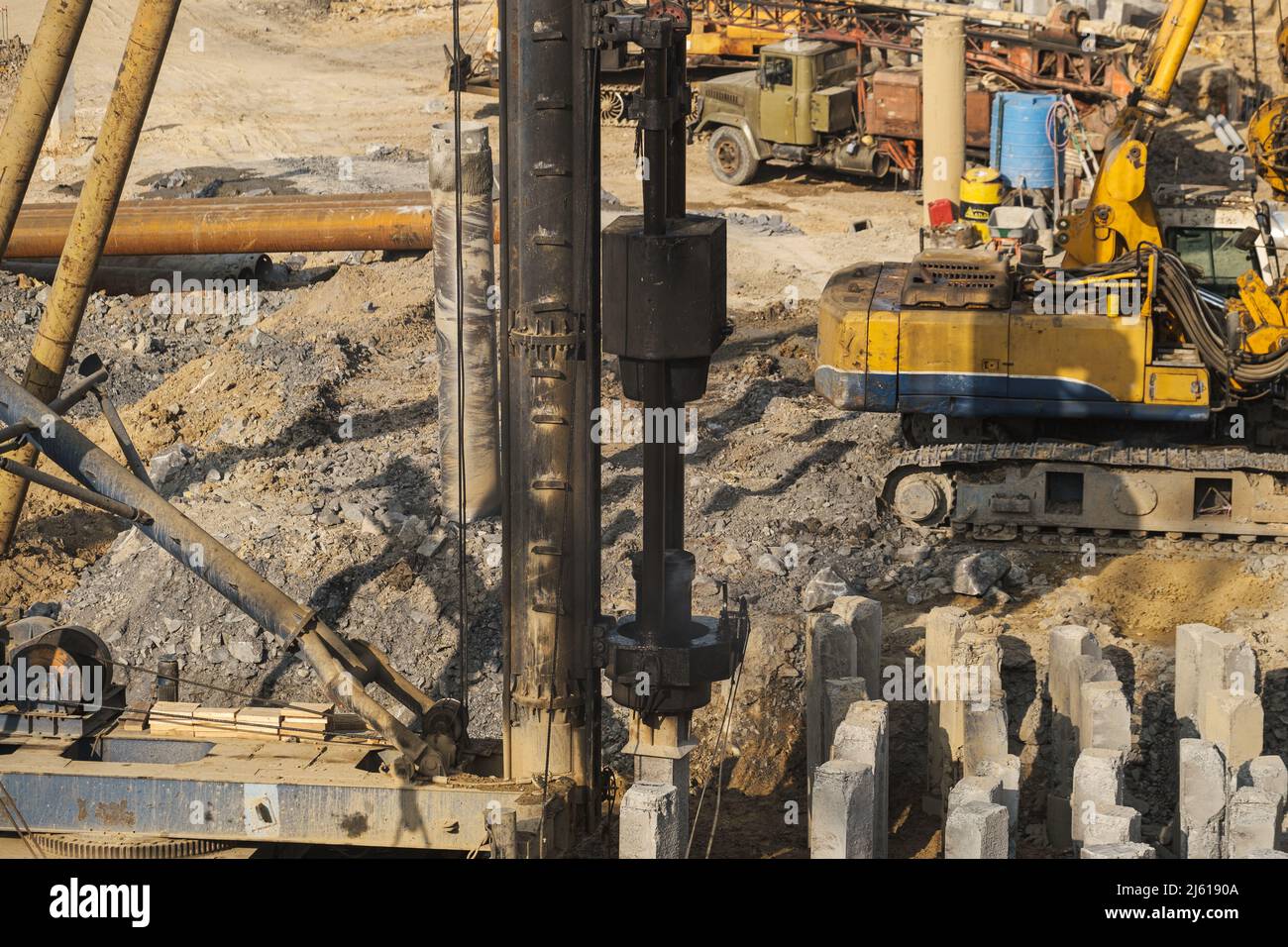 The pile driver drives the pile into the ground Stock Photo - Alamy