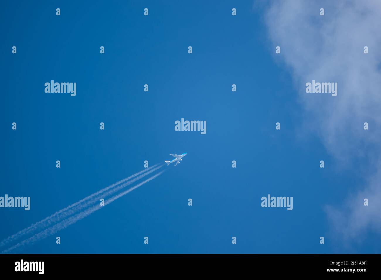 diagonal lower left to upper right high altitude contrails from a four ...