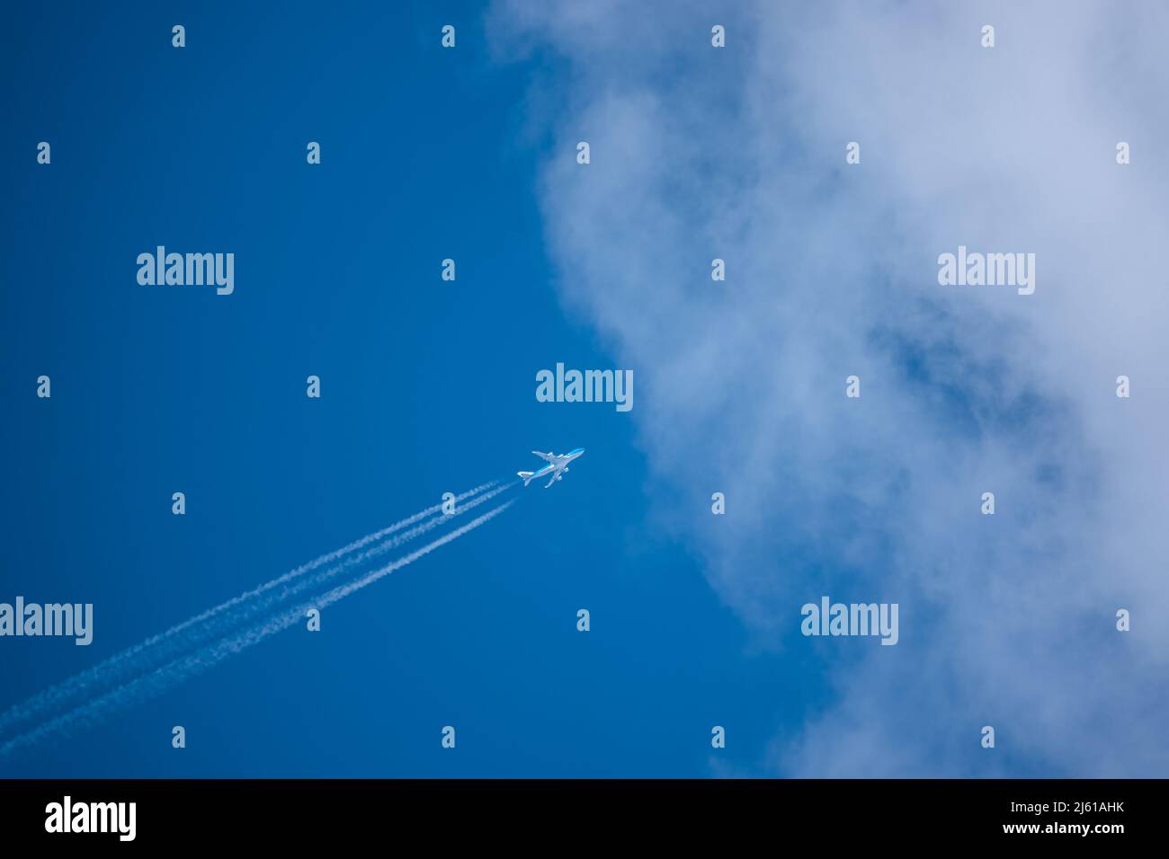 diagonal lower left to upper right high altitude contrails from a four ...