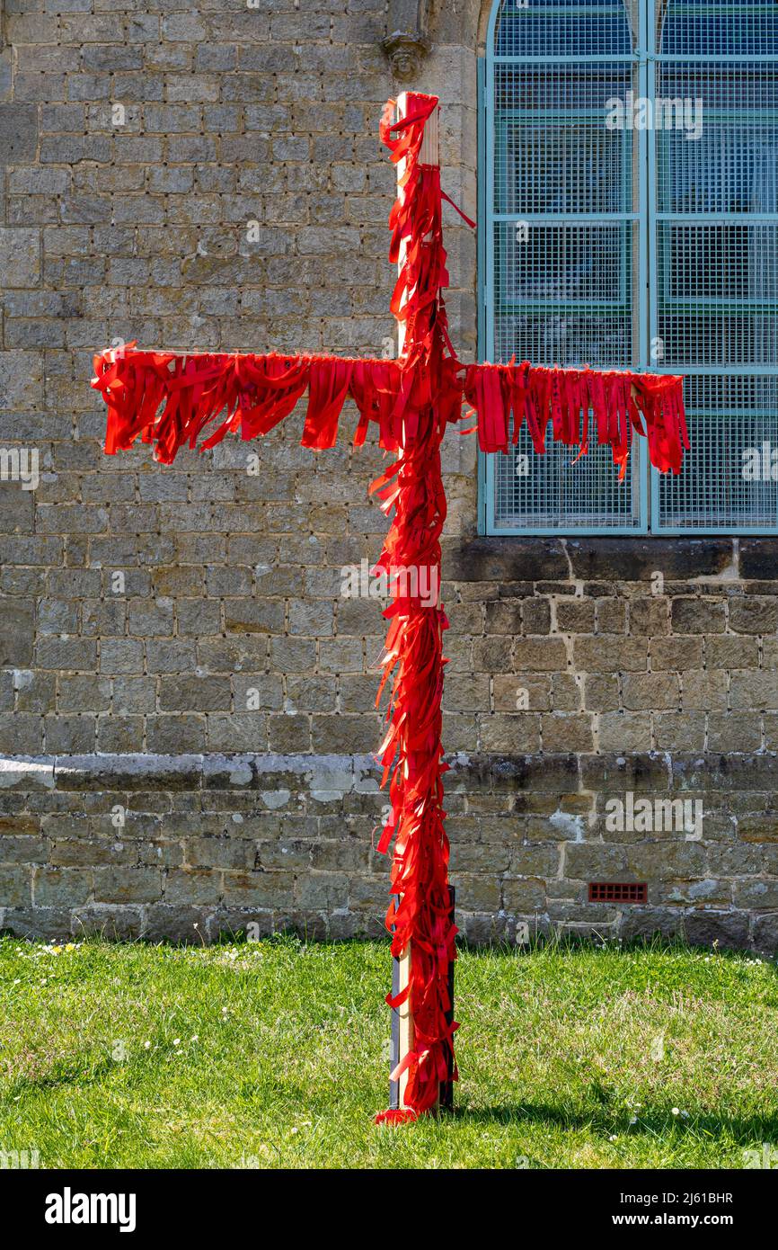 Easter cross decorated with red ribbons outside a church in Haslemere ...