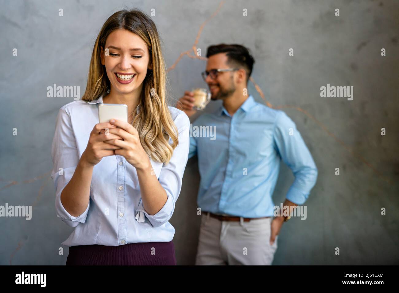 Happy businesswoman using mobile phone while analyzing weekly schedule ...