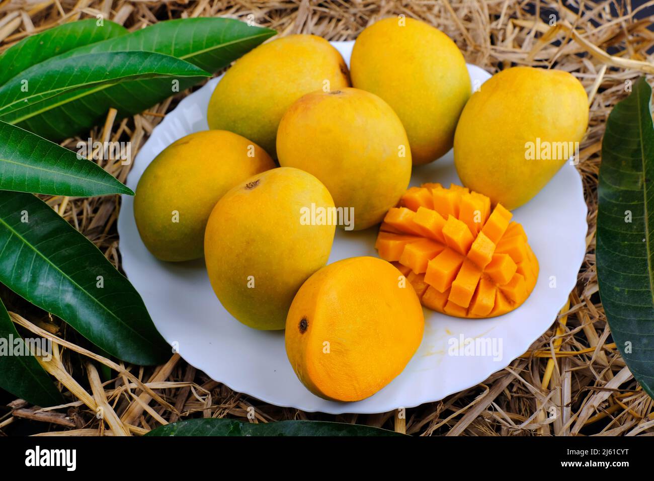Mango tropical fruit with green leaf, Ripe mango in grass closeup Stock ...