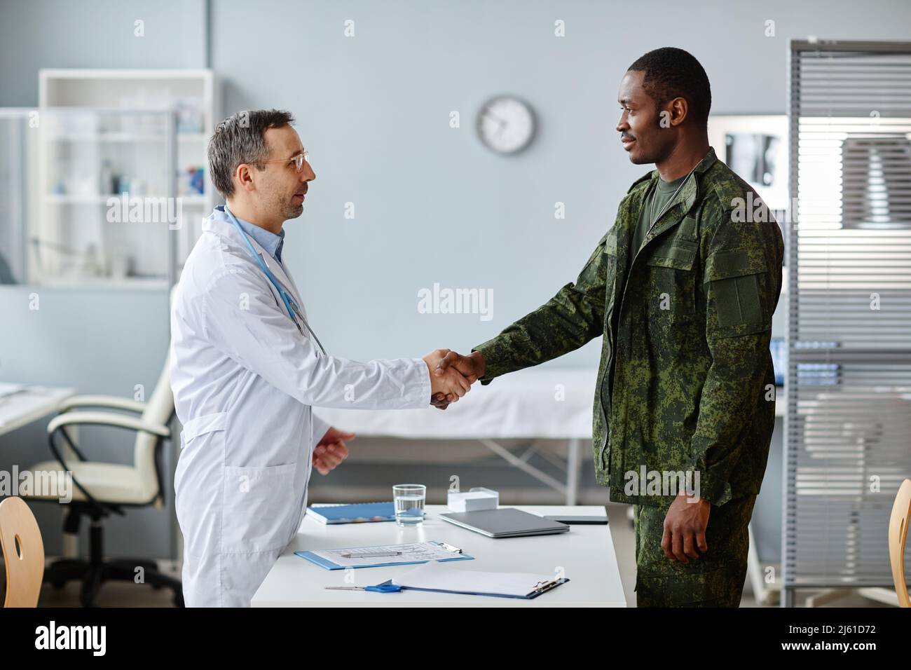 Side view of African American military officer and Caucasian doctor ...