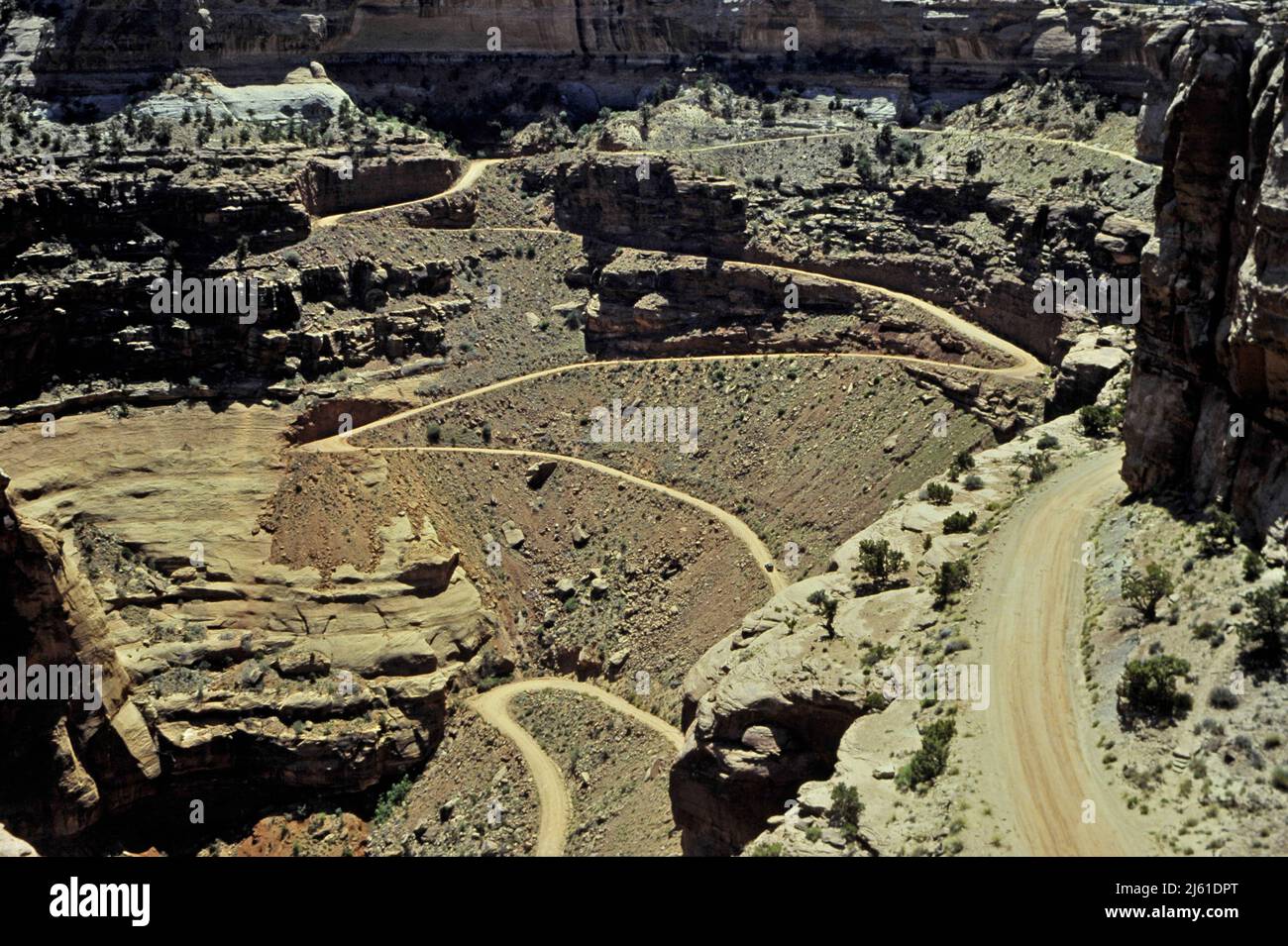 striking scenery of a curvy dirt road along steep cliffs in the USA ...