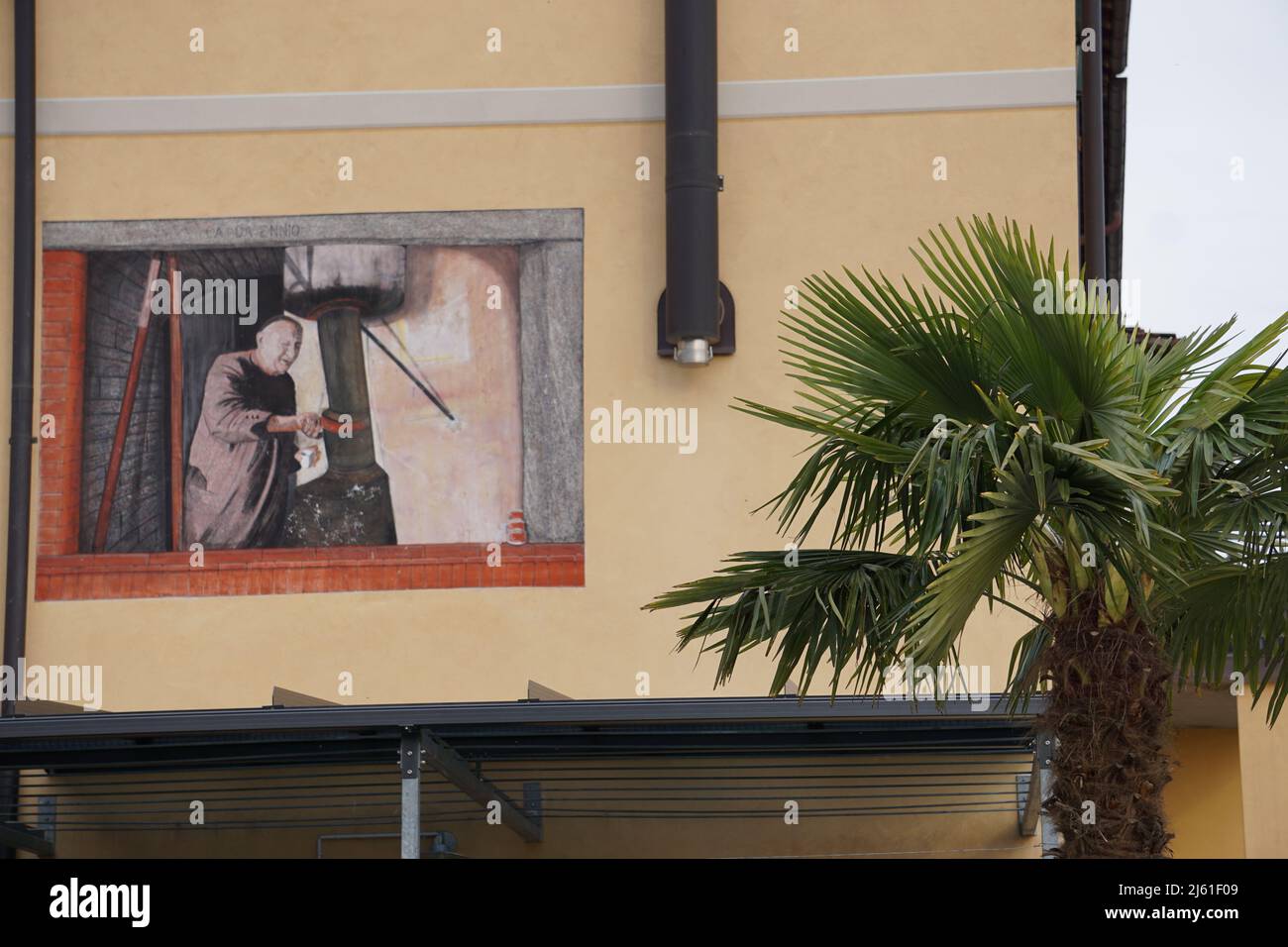 painting of old monk by stove on wall on building Stock Photo - Alamy