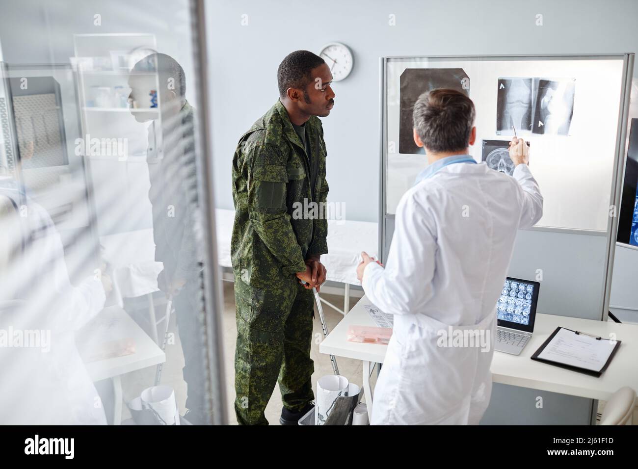 Young African American military officer using walking stick after ...