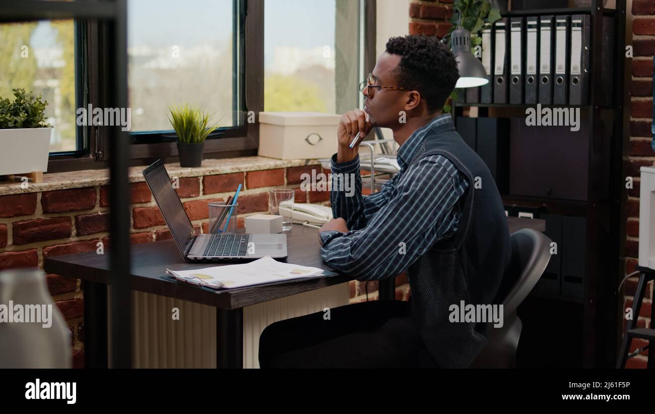 Pensive worker brainstorming ideas about future opportunity, thinking ...