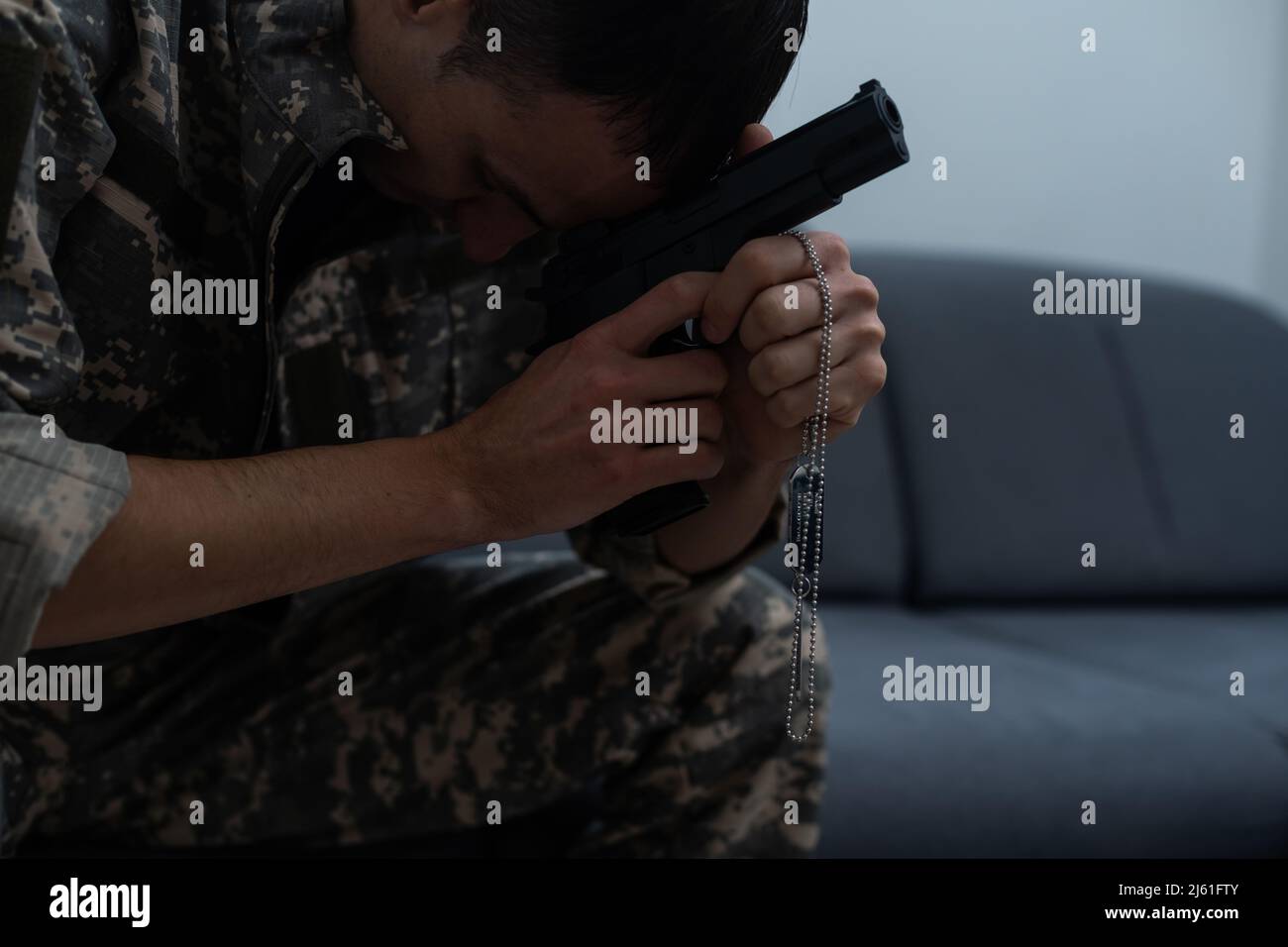 A army soldier takes aim with a pistol gun in his hands to the screen ...