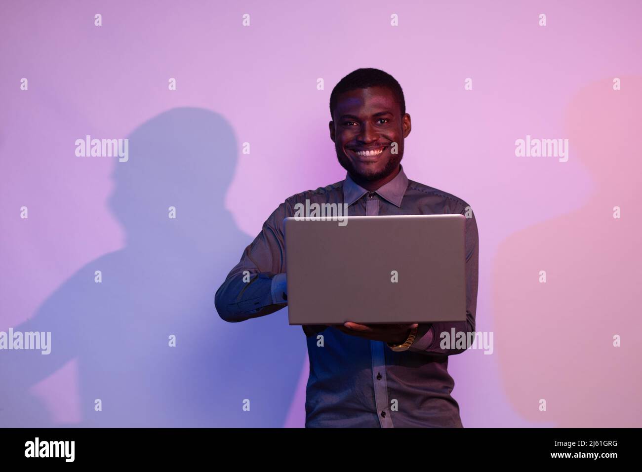 Excited man using laptop typing hi-res stock photography and images - Alamy