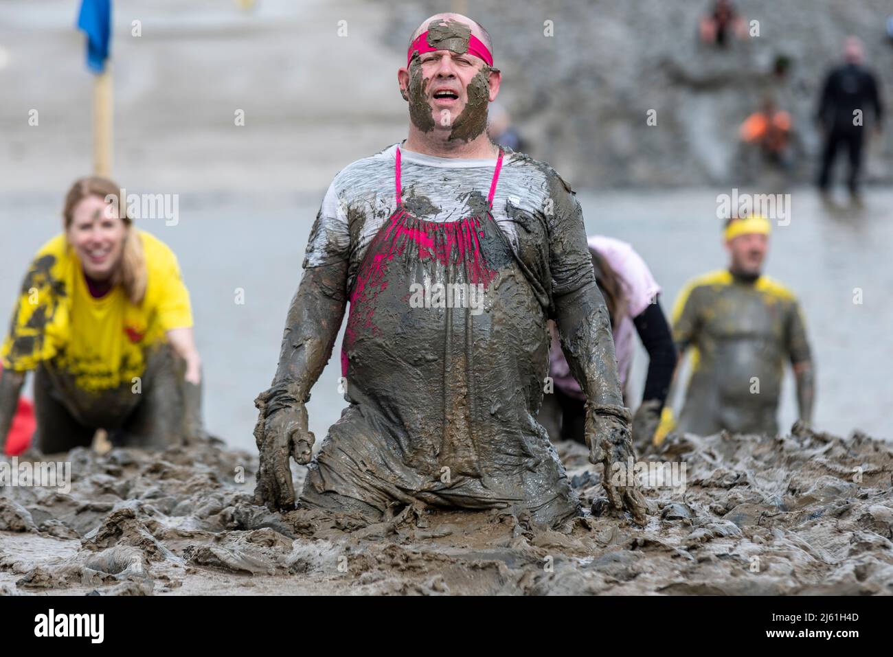 Male taking a rest after crawling in mud at the Maldon Mud Race 2022 on ...