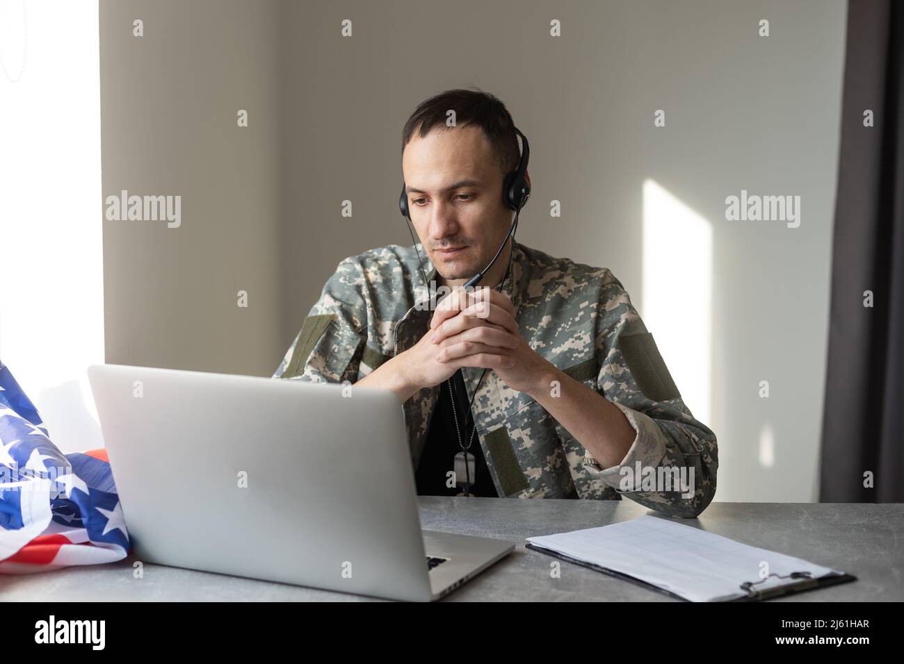 Soldier working with laptop in headquarters building Stock Photo - Alamy