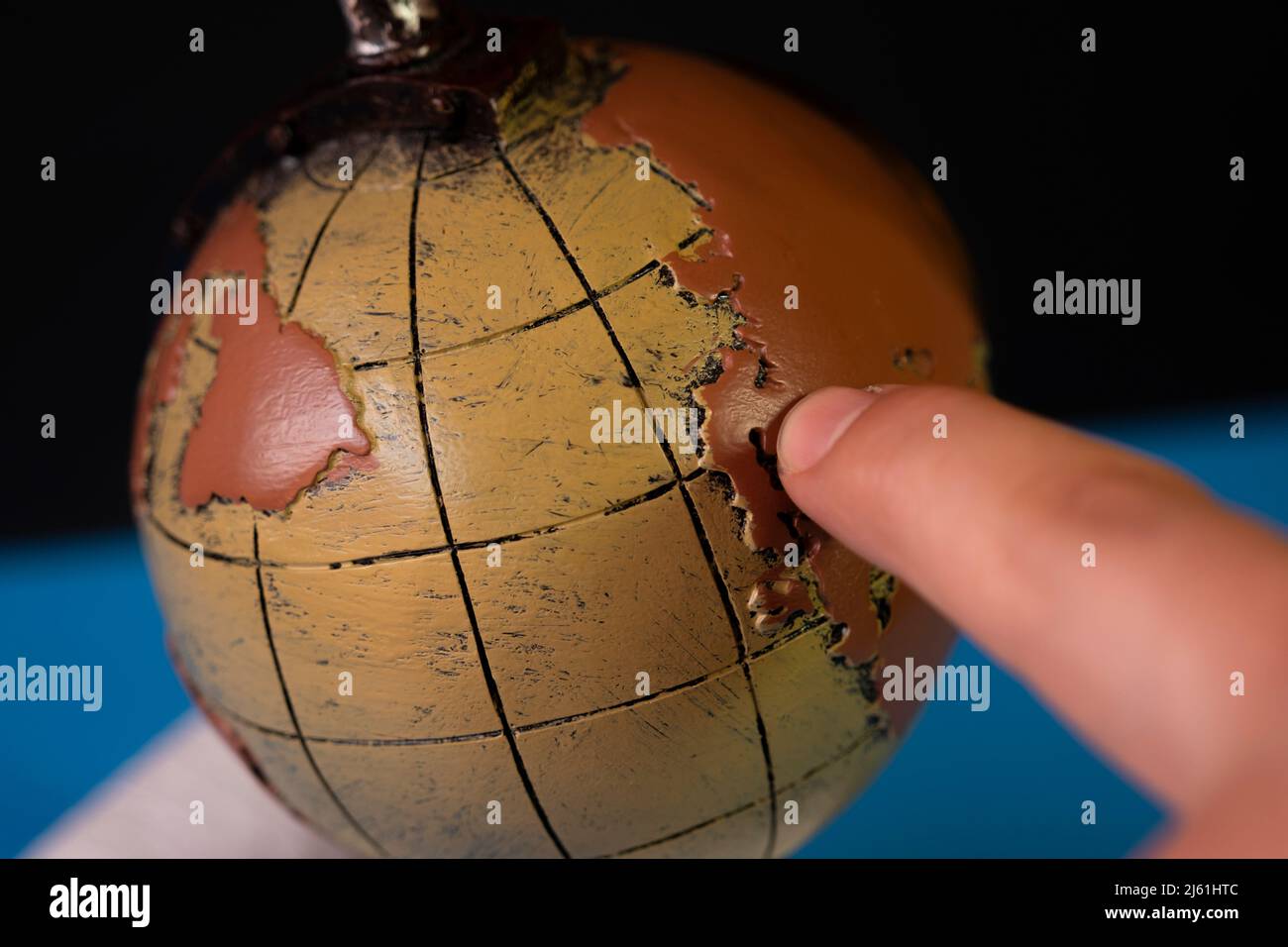 Earth statue, point out with finger, close up, travel concept, decide ...