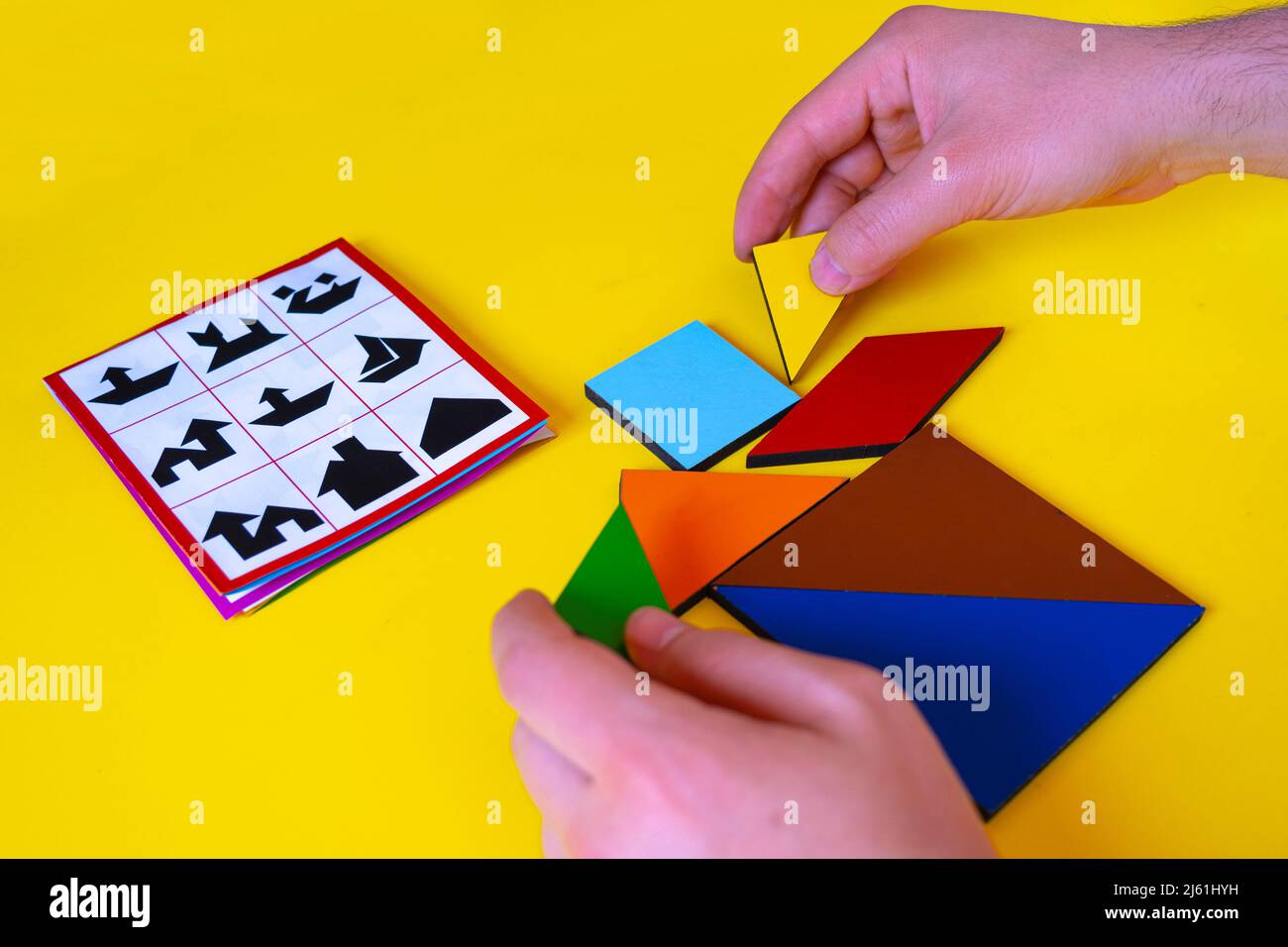 Man hand playing tangram and making house, kids game concept, colorful ...