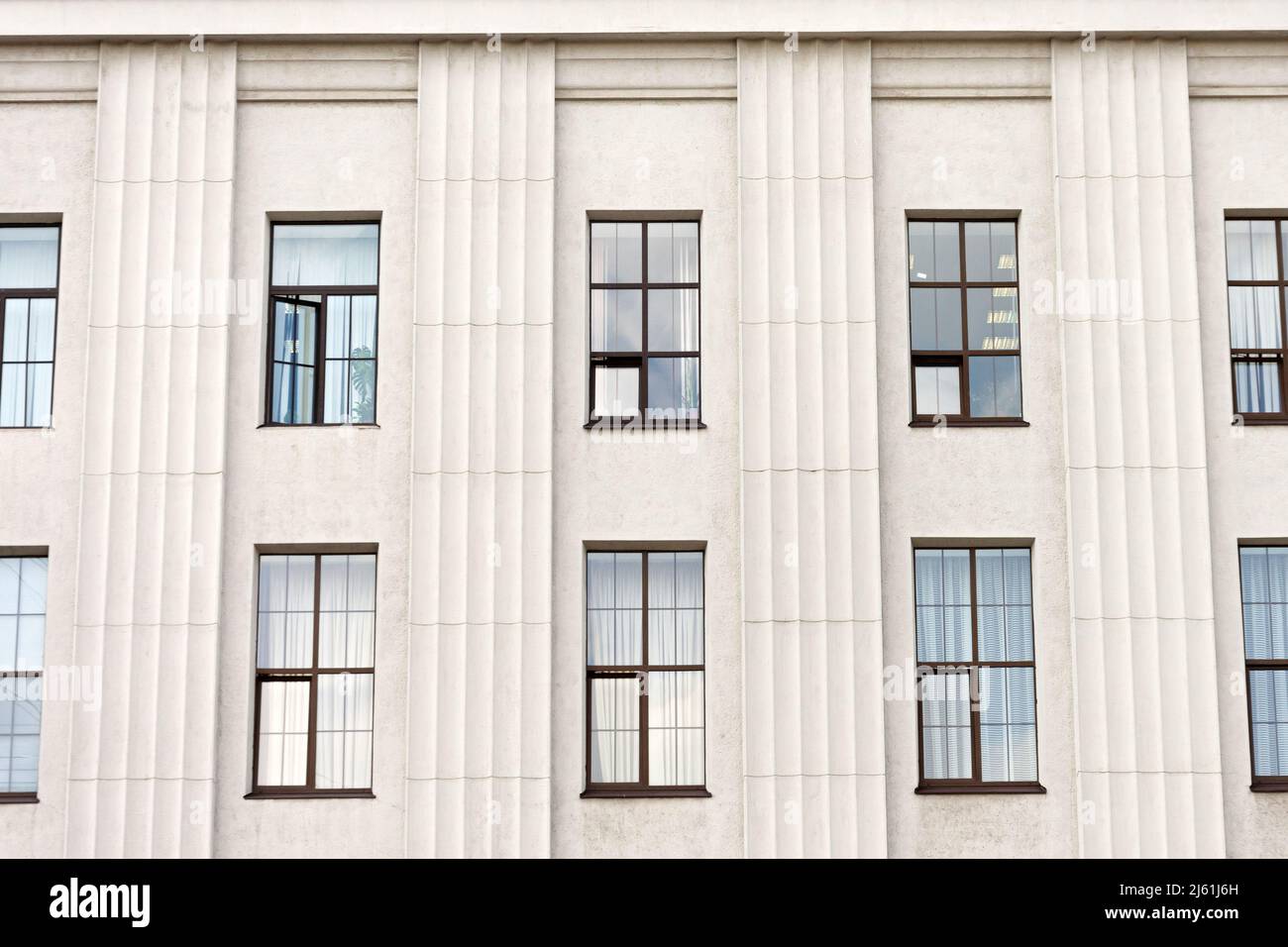 Elongated windows with columns exterior building in gray Stock Photo ...