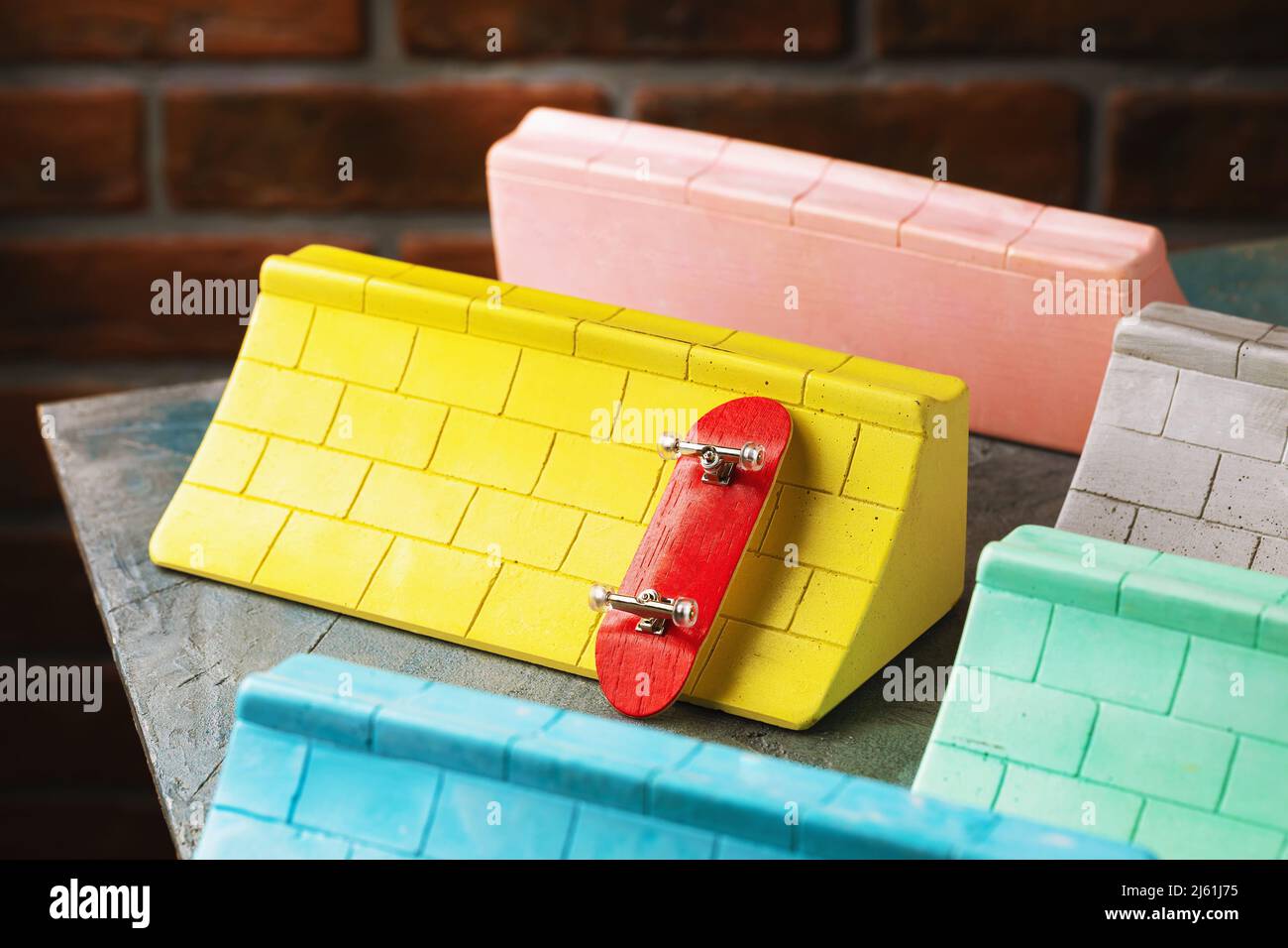 Multi-colored plaster ramps and fingerboard on the table, close-up ...