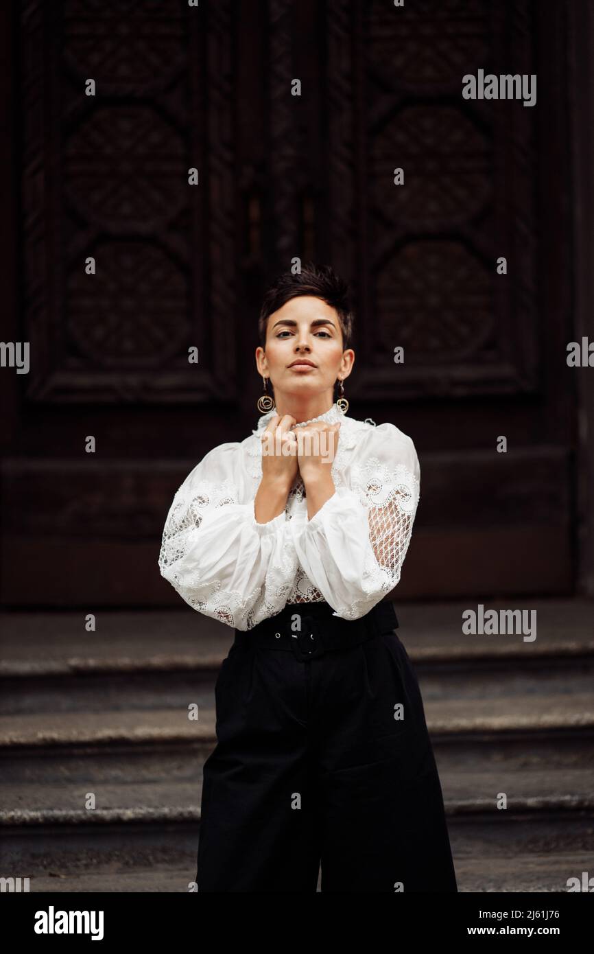 Portrait of beautiful woman in stylish formal wear at the park ...
