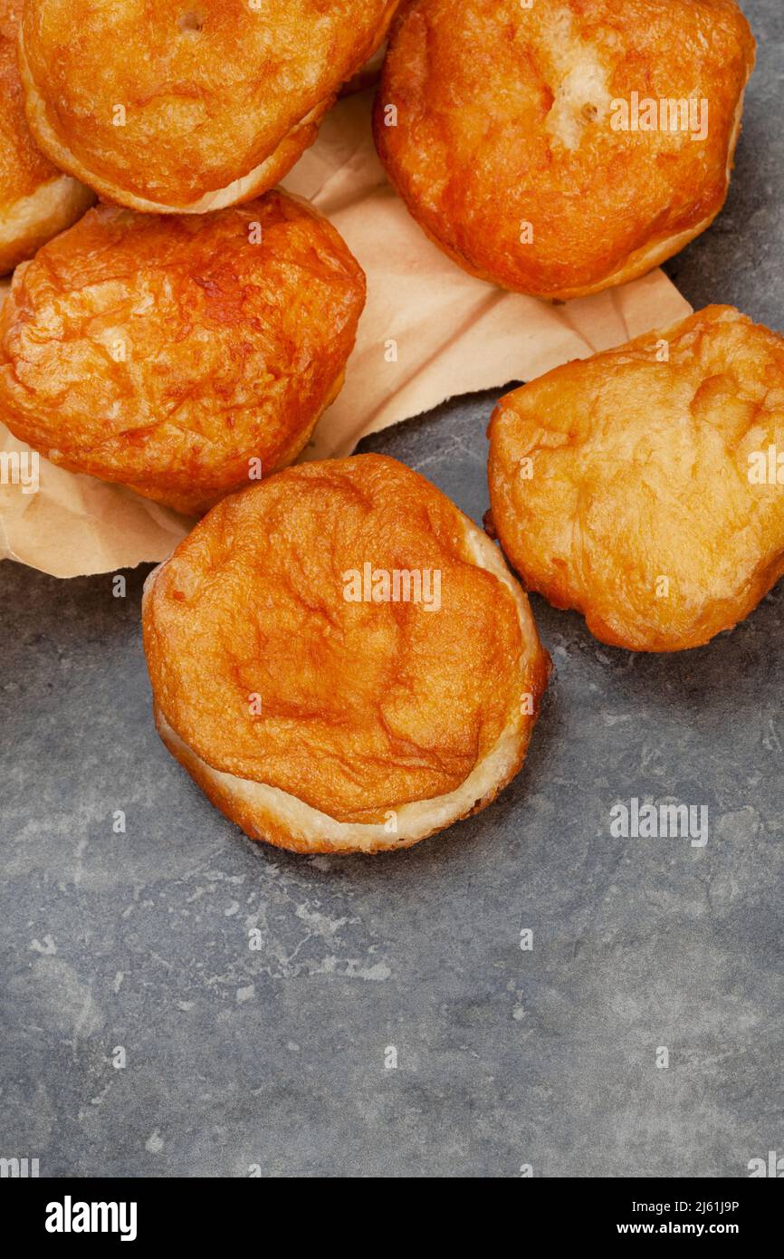 South African vetkoek, deep fried savory dough, on mottled grey ...