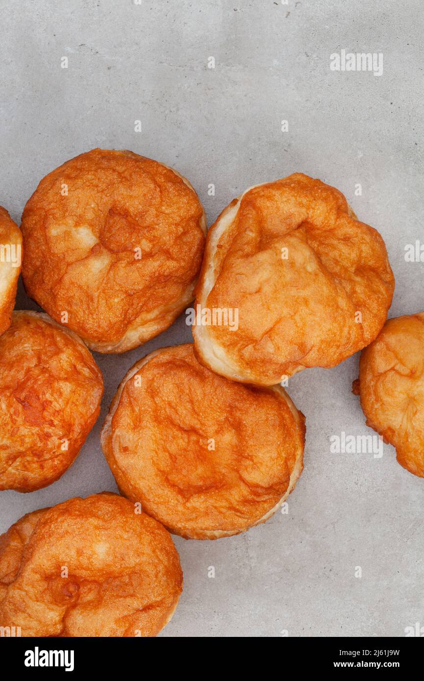 South African vetkoek, deep fried savory dough, on mottled grey ...