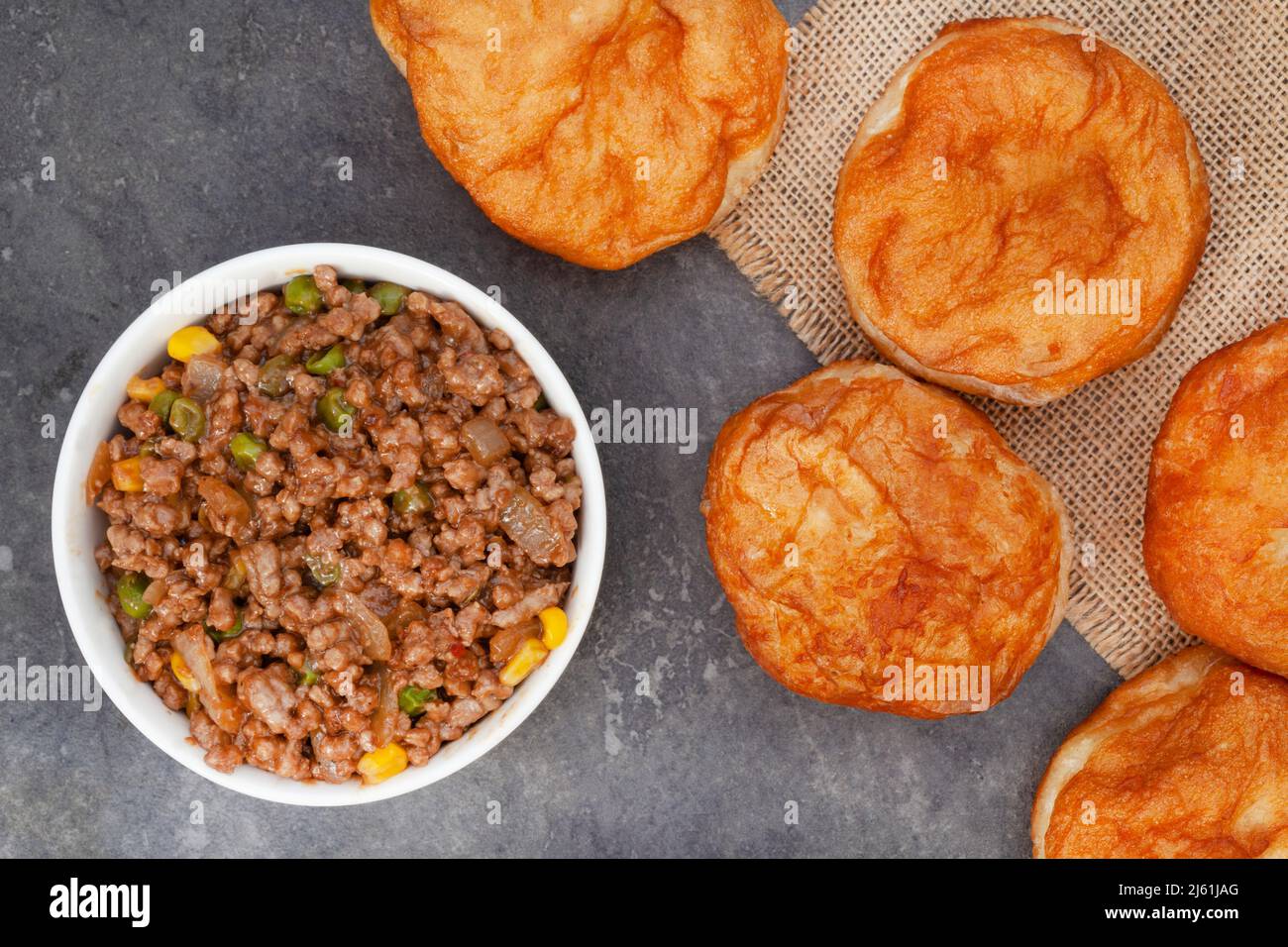 South African vetkoek, deep fried savory dough filled with saucy savory ...