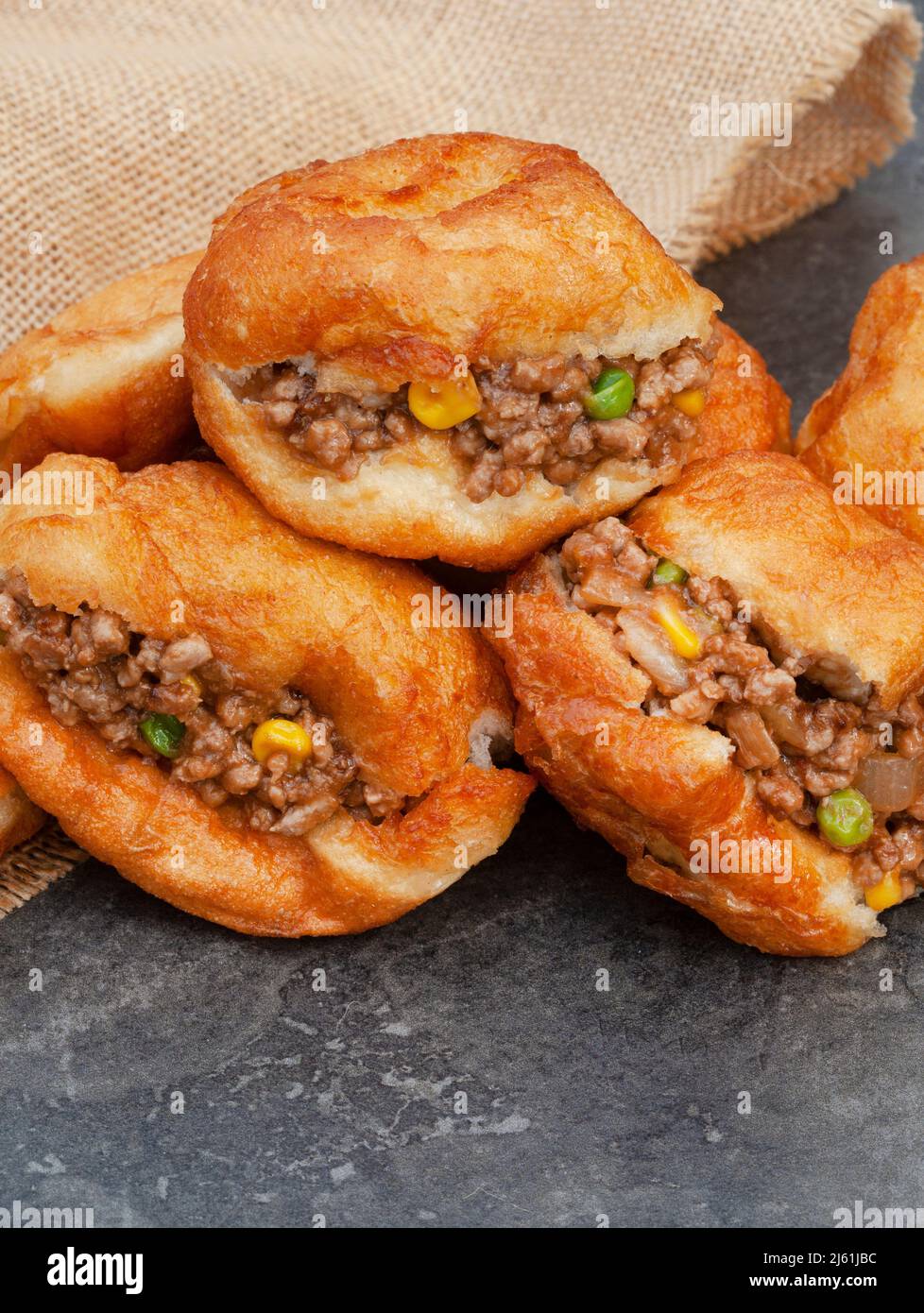 South African vetkoek, deep fried savory dough filled with saucy savory ...