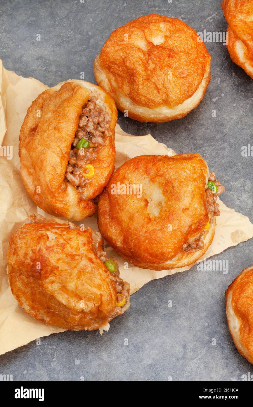 South African vetkoek, deep fried savory dough filled with saucy savory ...