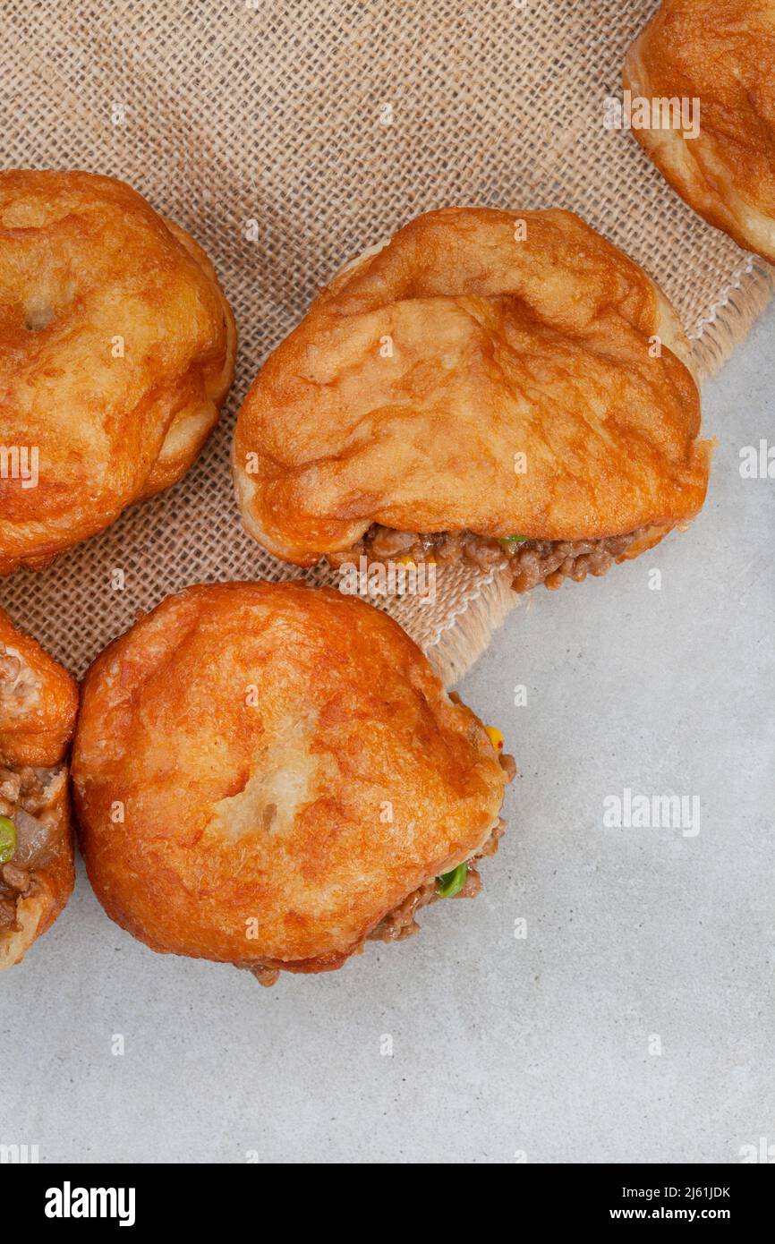 South African vetkoek, deep fried savory dough filled with saucy savory ...