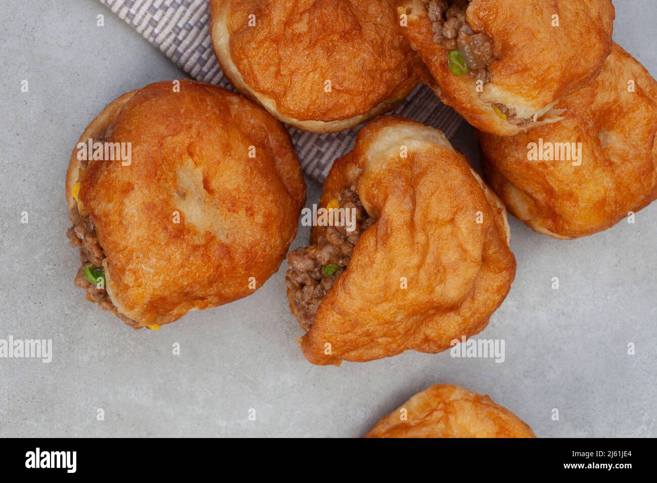 South African vetkoek, deep fried savory dough filled with saucy savory ...