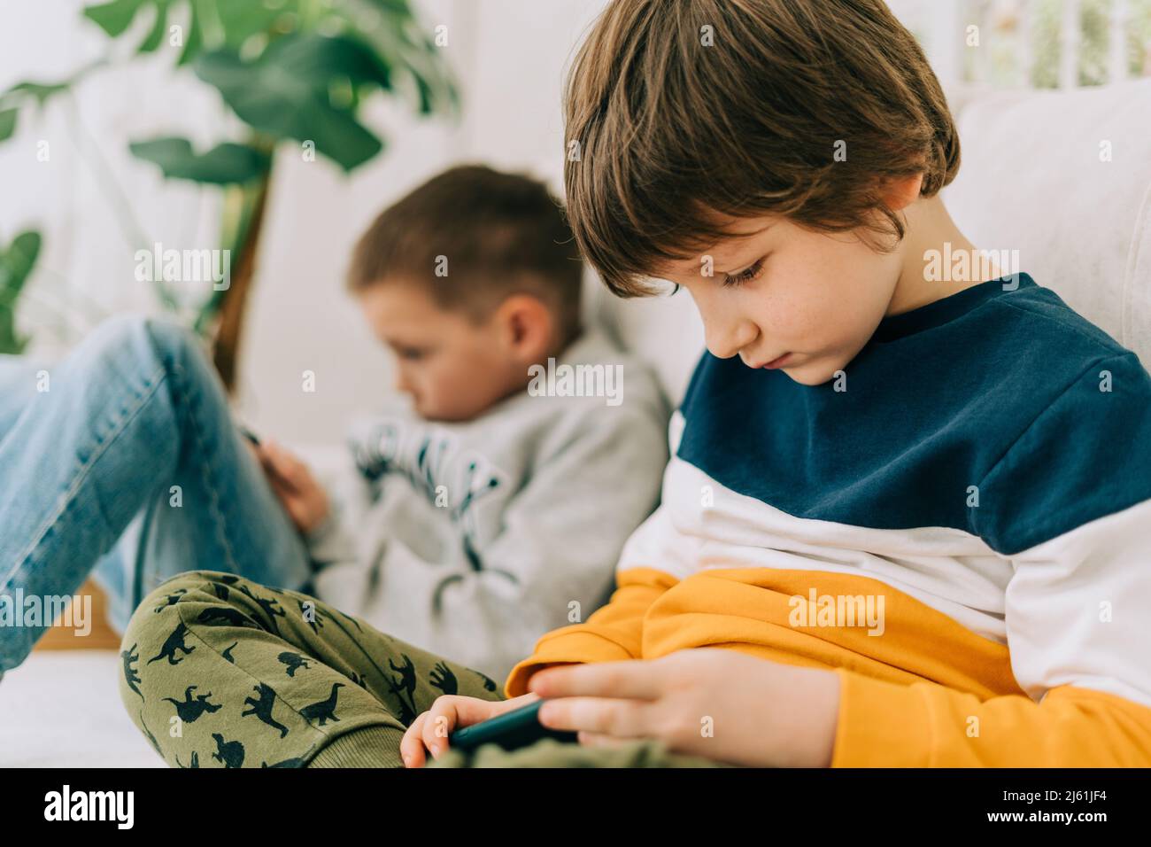 Cheerful two Childs boys playing online game, watching video on ...