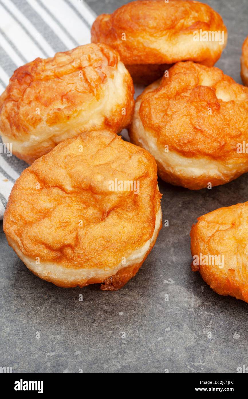 South African vetkoek, deep fried savory dough, on mottled grey ...