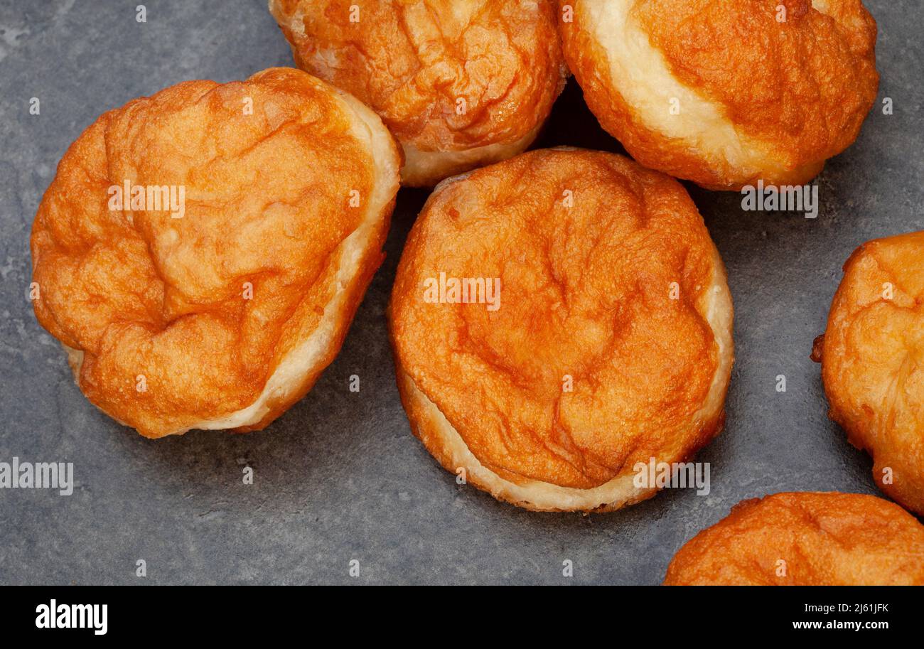 South African vetkoek, deep fried savory dough, on mottled grey ...