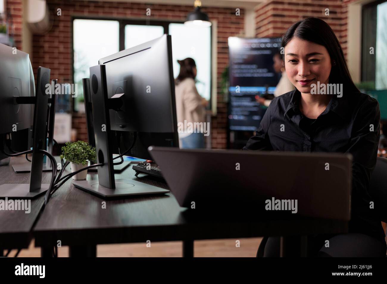 Confident cyber security officer accesing administrator rights by bypassing firewall defence ...