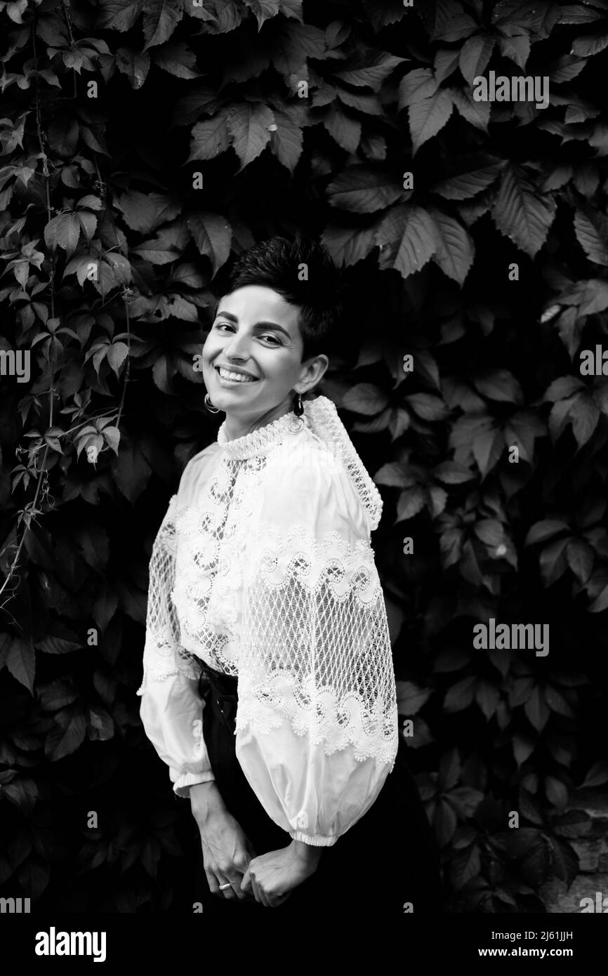 Portrait of beautiful woman in stylish formal wear at the park ...