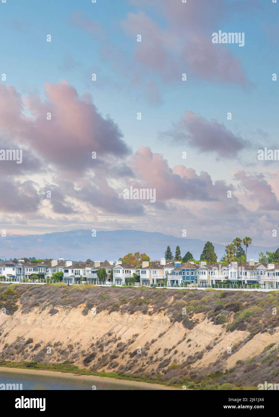 Vertical Puffy clouds at sunset Newport Beach neigborhood near the ...