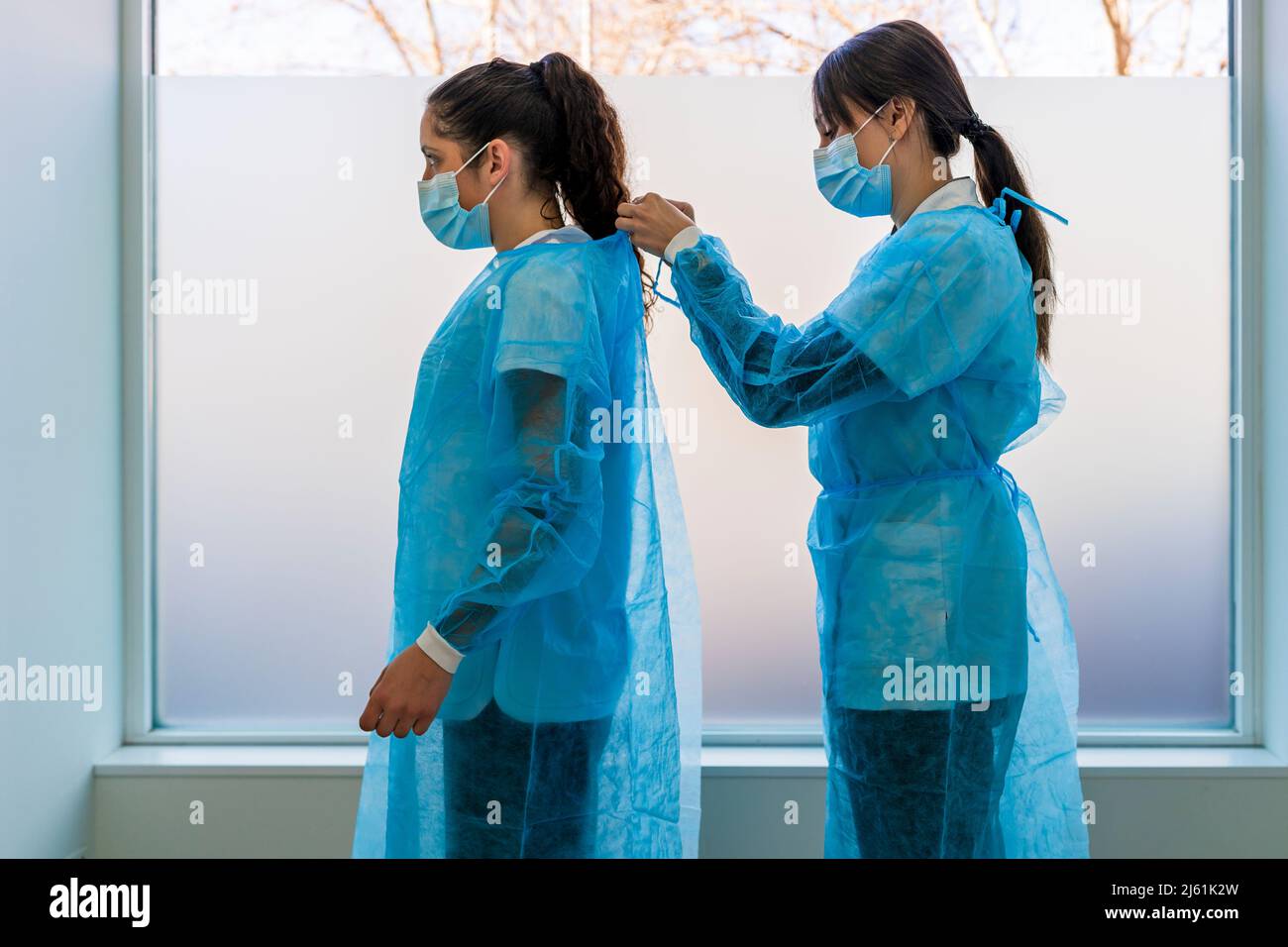 Helping in wearing mask hi-res stock photography and images - Alamy