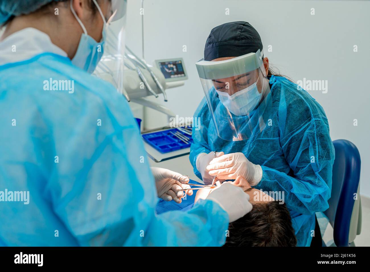 Surgeon with nurse doing surgery of patient in operating room at ...