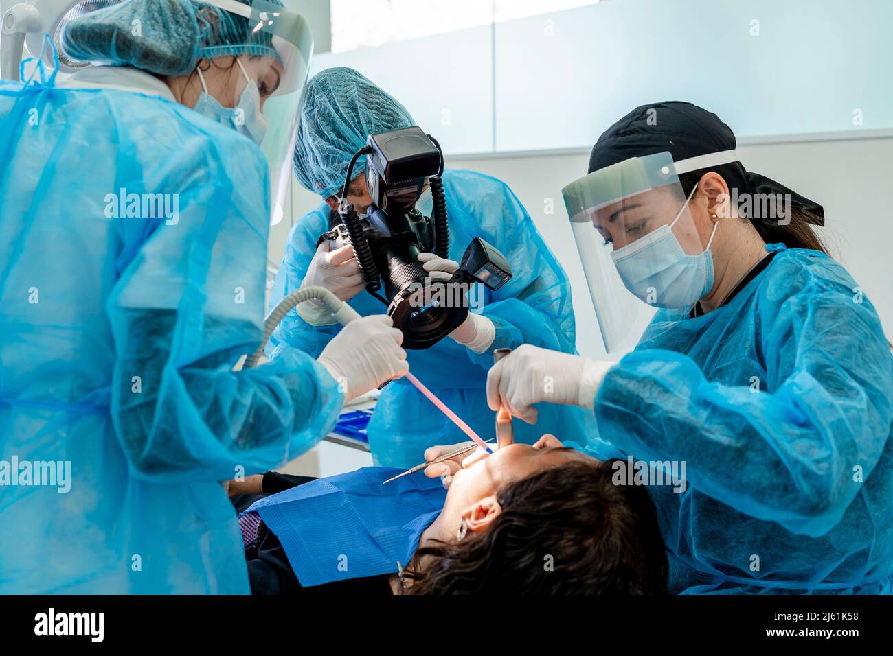 Surgeon with nurses operating patient in surgery room at hospital Stock ...