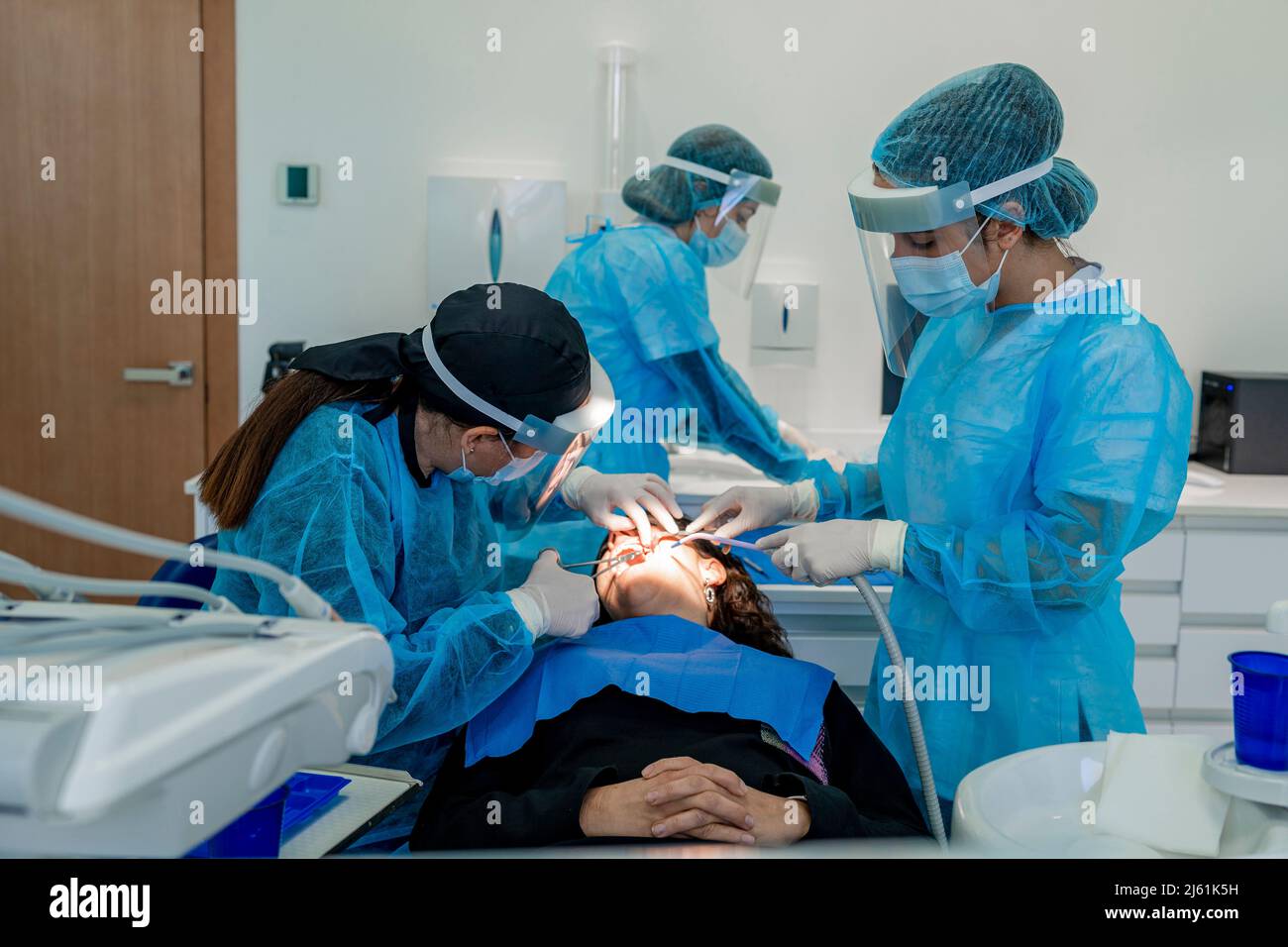 Surgeon with nurses doing surgery of patient in operating room at ...